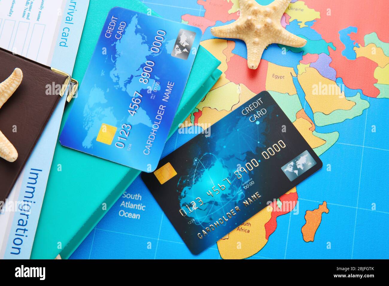 Credit cards on world map background Stock Photo - Alamy