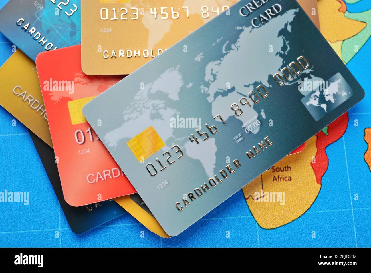 Credit cards on world map background Stock Photo - Alamy