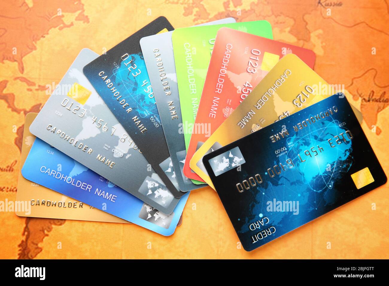 Credit cards on world map background Stock Photo - Alamy