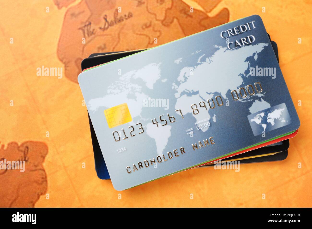 Credit cards on world map background Stock Photo - Alamy