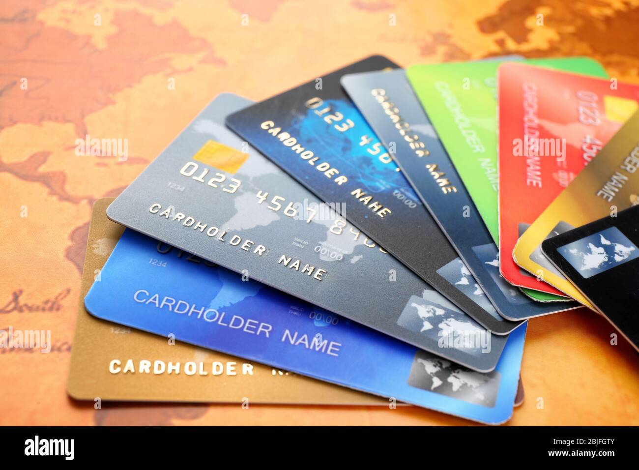 Credit cards on world map background Stock Photo - Alamy