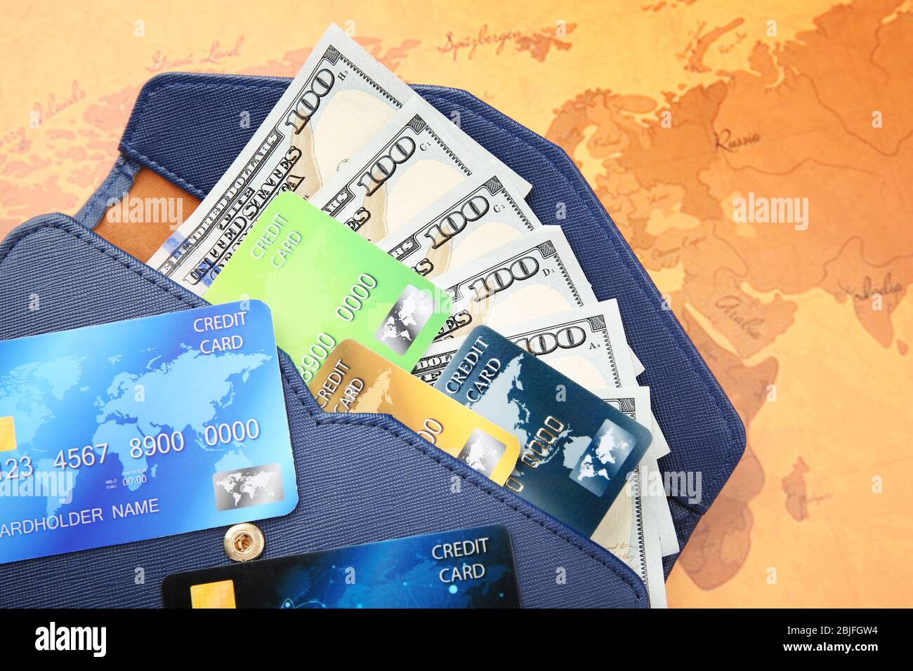 Credit cards with money in wallet on world map background Stock Photo ...