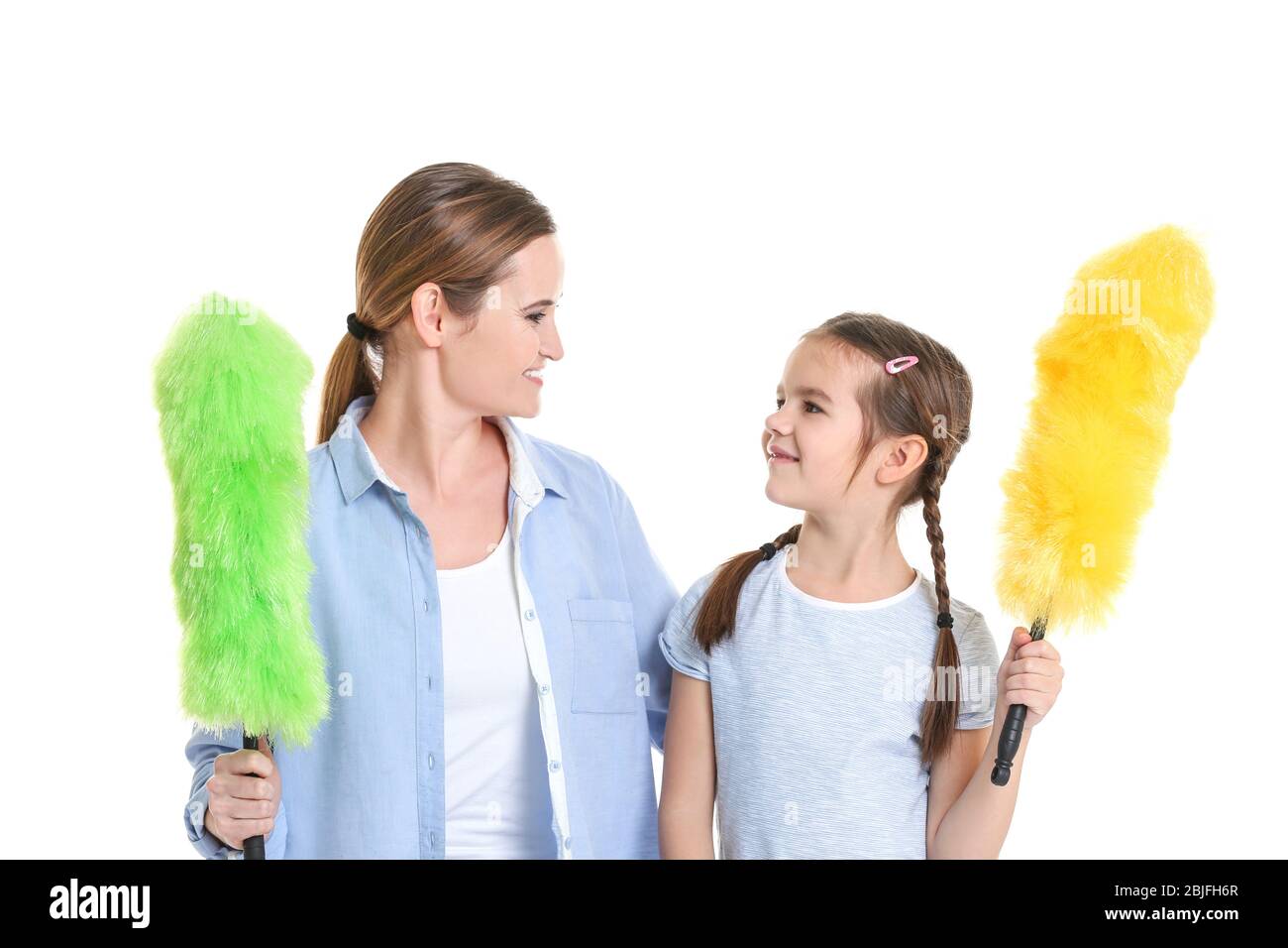 Mother and daughter with dusters, isolated on white Stock Photo - Alamy