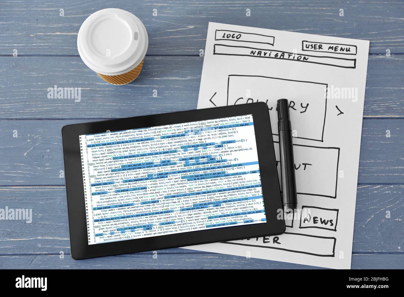 Programmer concept. Digital tablet, flowchart and cup of coffee on grey ...