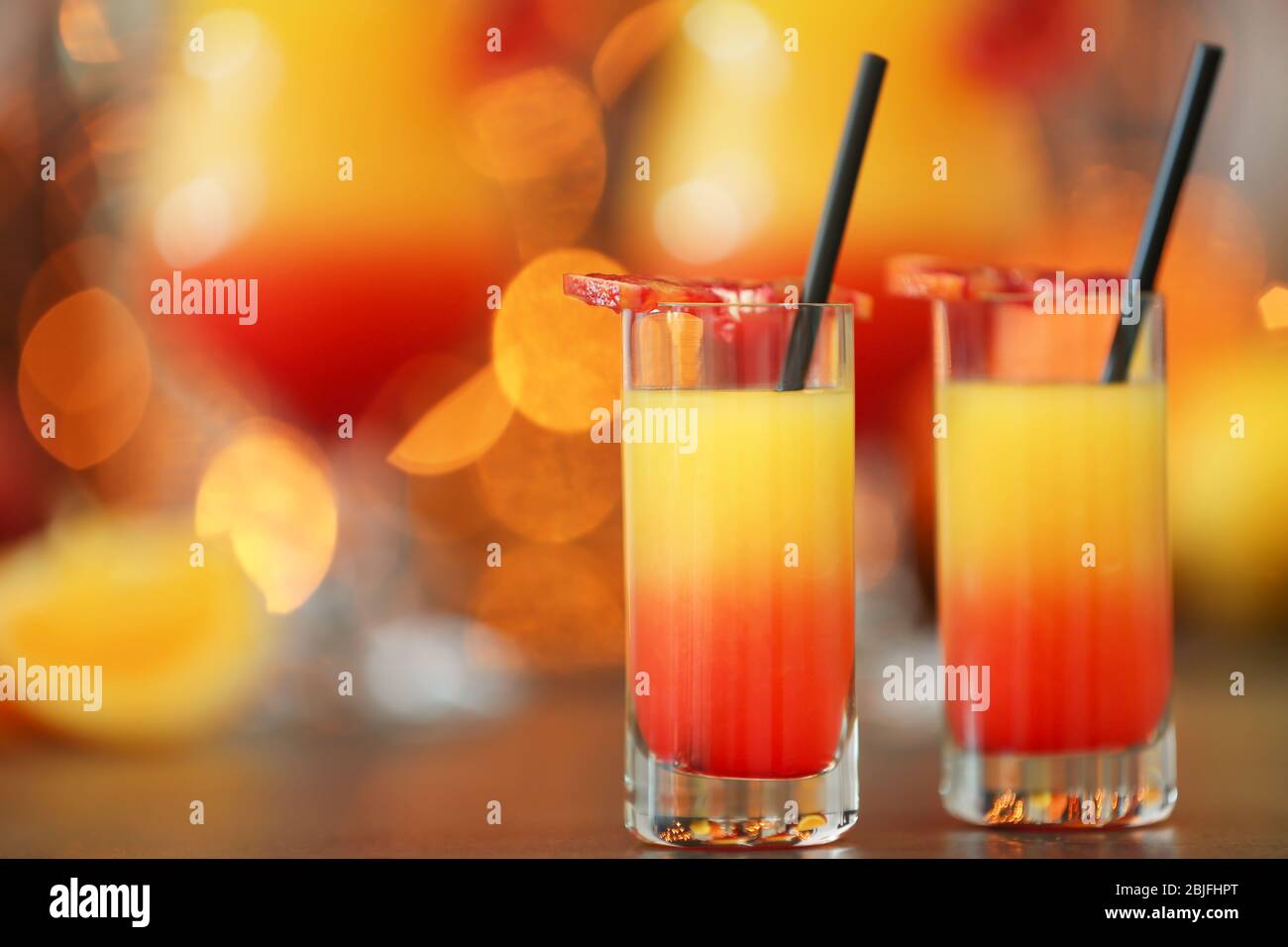 Delicious tequila sunrise cocktails on bokeh lights background Stock ...