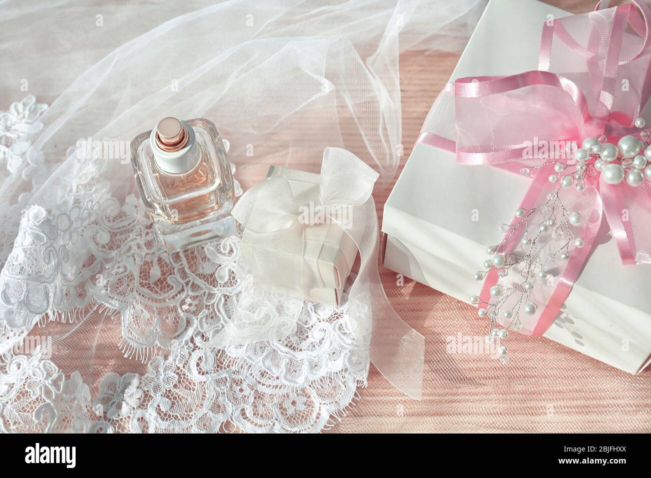 Beautiful gift boxes, perfume and bridal veil on light background Stock ...