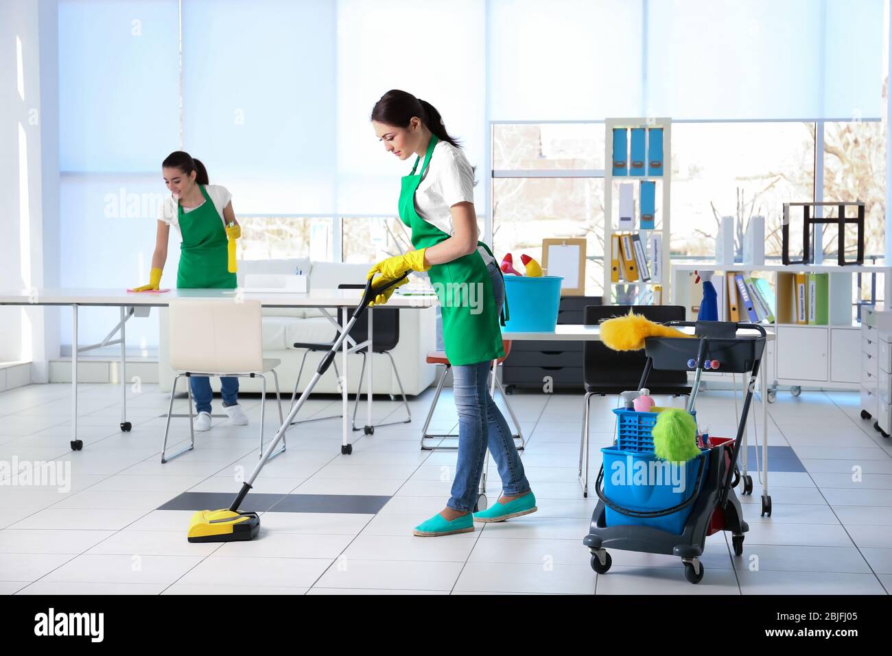 Cleaning service team working in office Stock Photo - Alamy
