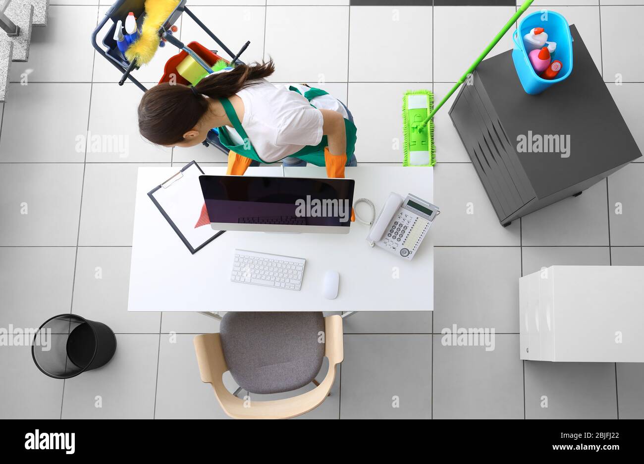 Woman wiping office floor hi-res stock photography and images - Alamy