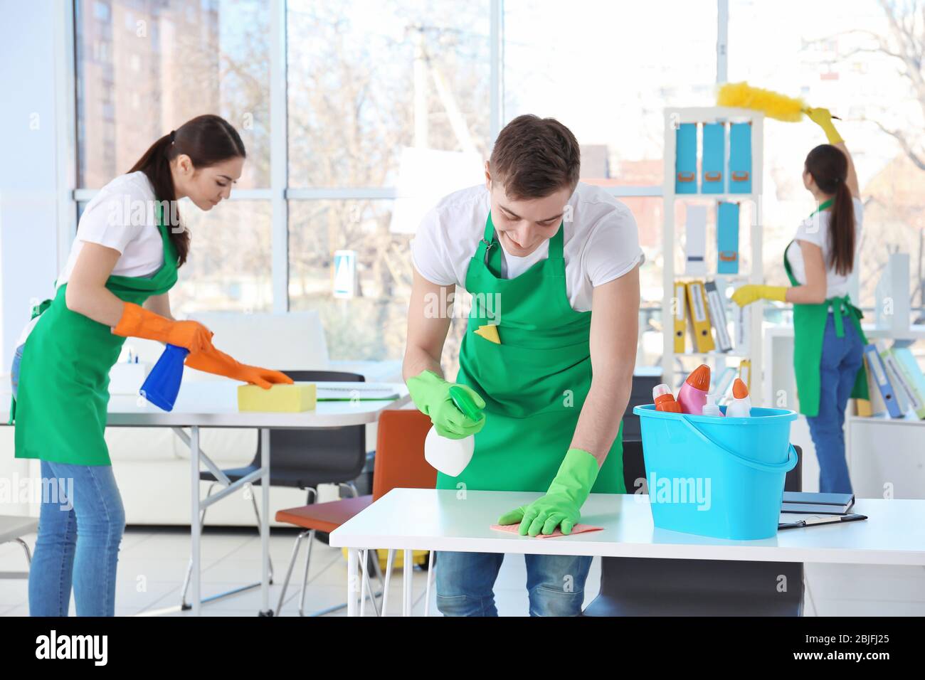 Cleaning service team working in office Stock Photo - Alamy