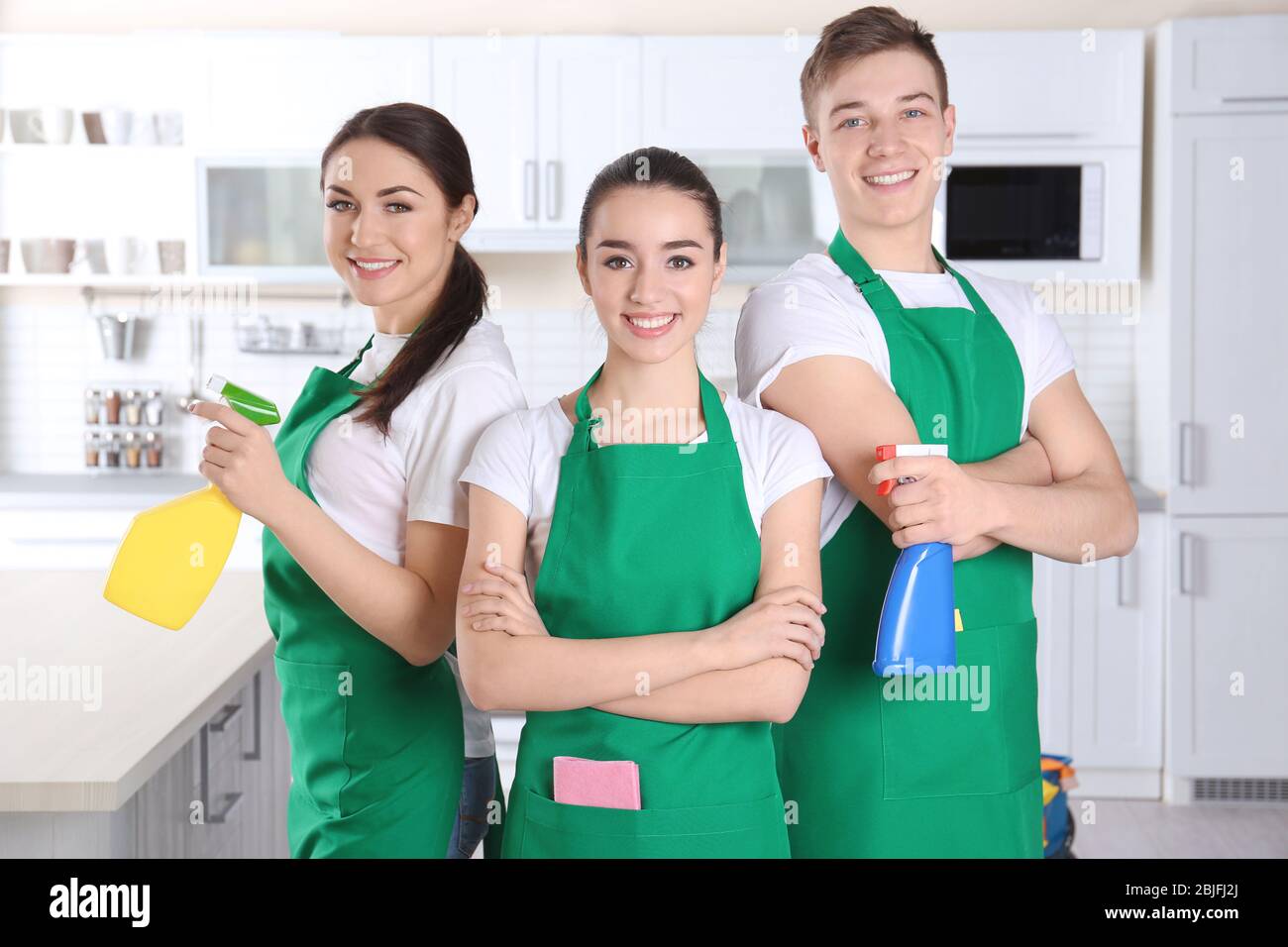 Cleaning service team working in kitchen Stock Photo - Alamy