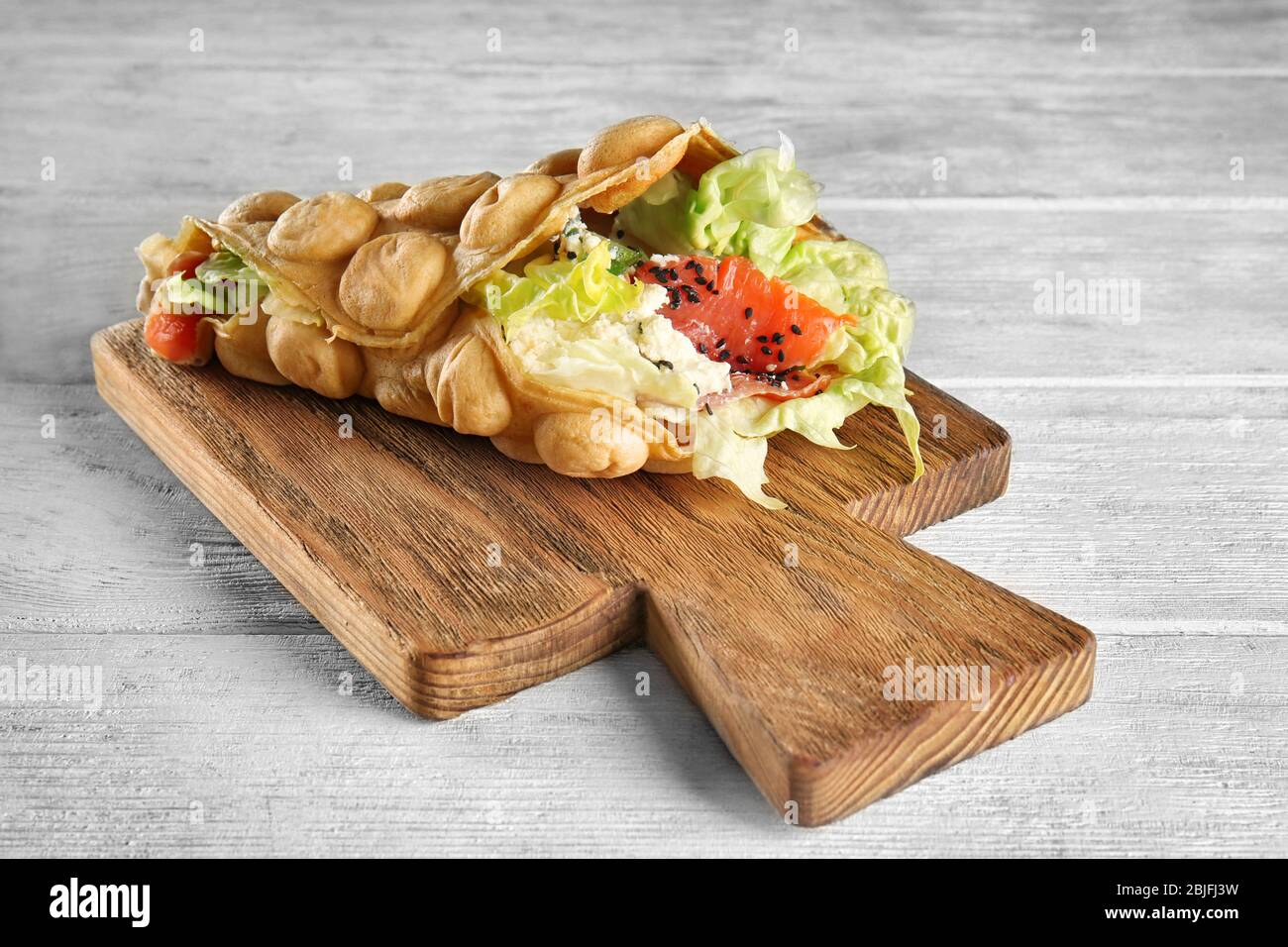 Tasty street food wafer on cutting board Stock Photo - Alamy