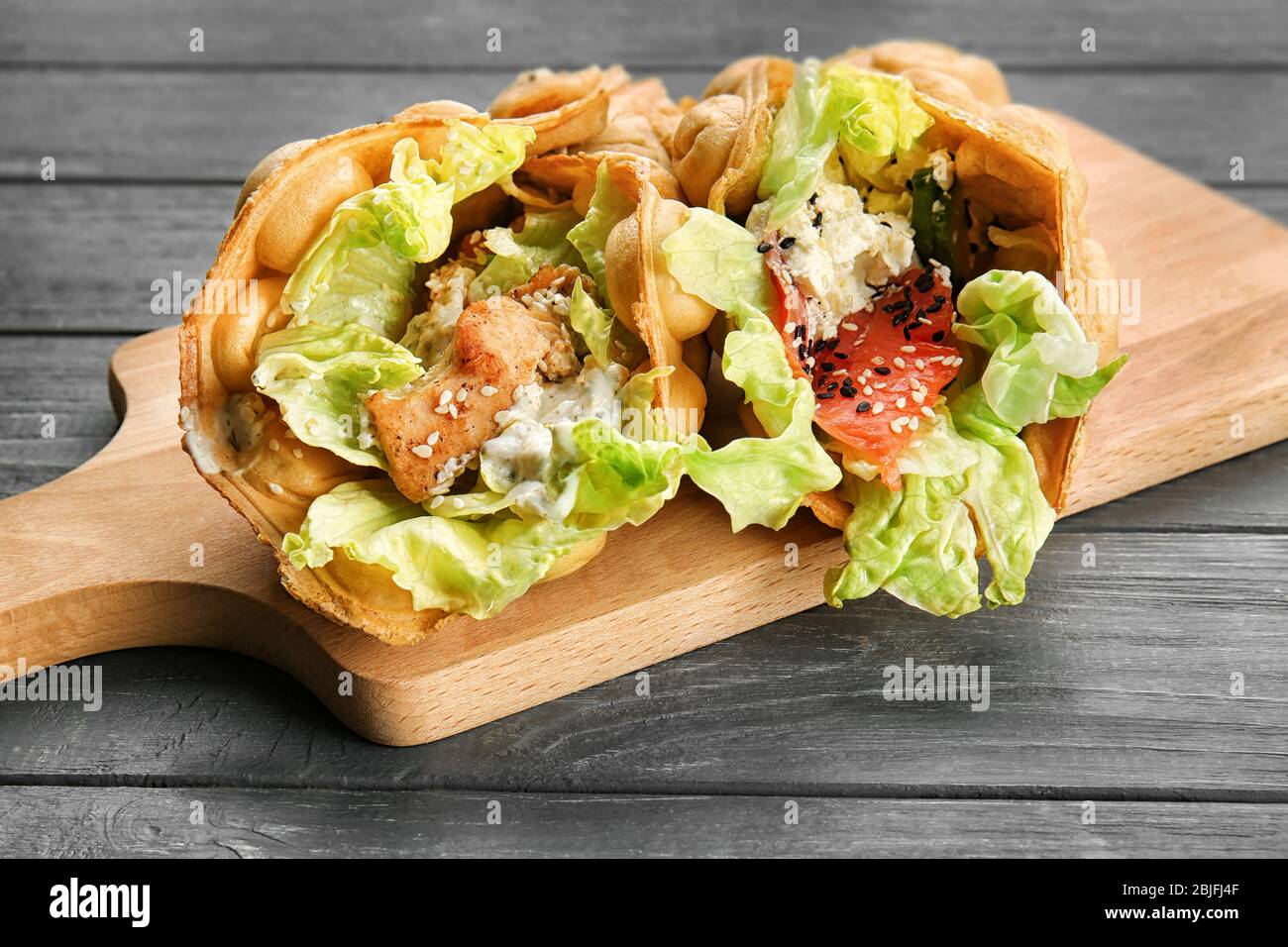 Tasty street food wafers on cutting board Stock Photo - Alamy