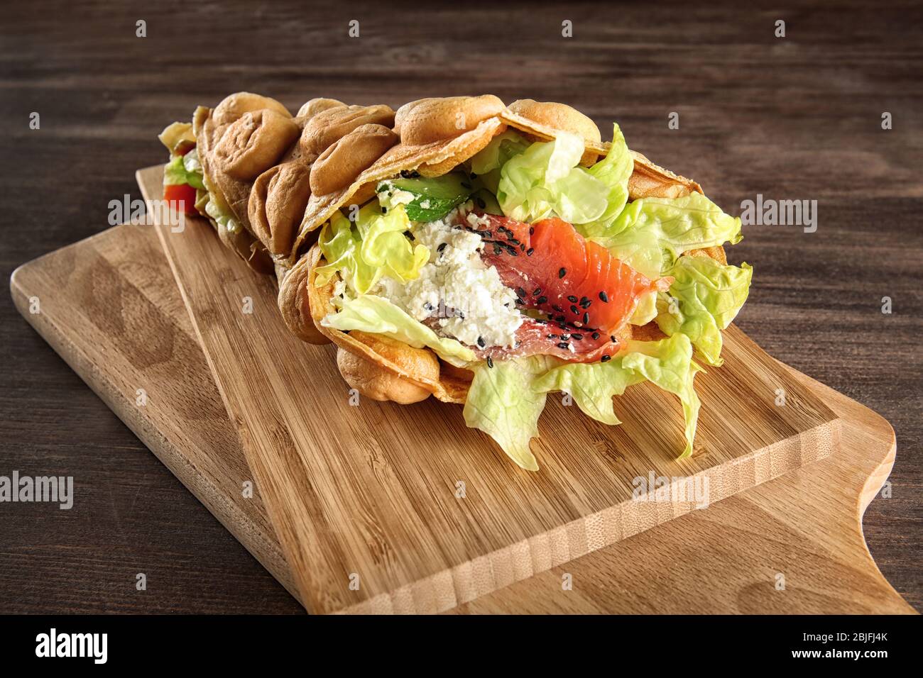 Tasty street food wafer on cutting board Stock Photo - Alamy