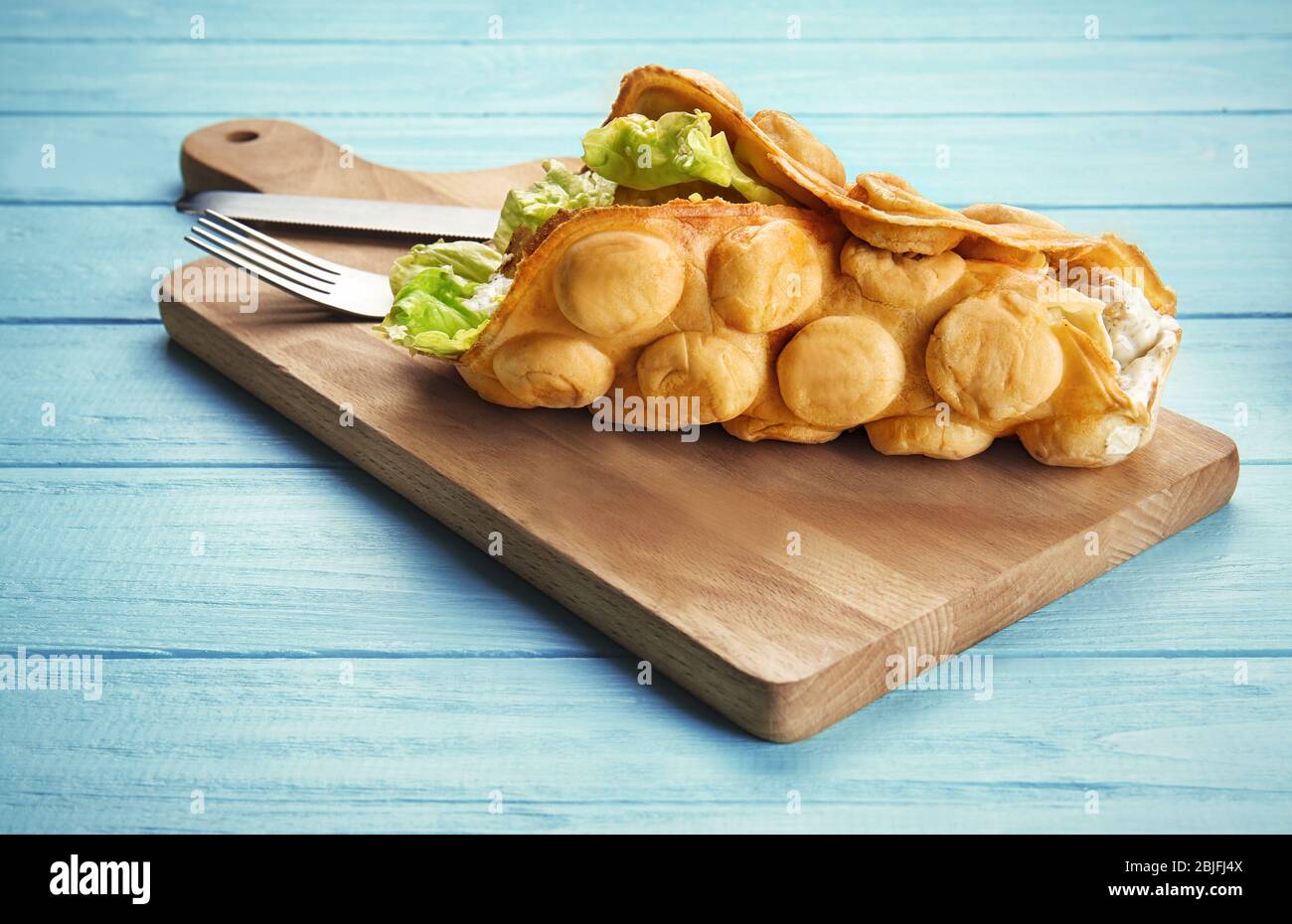 Tasty street food wafer on cutting board Stock Photo - Alamy