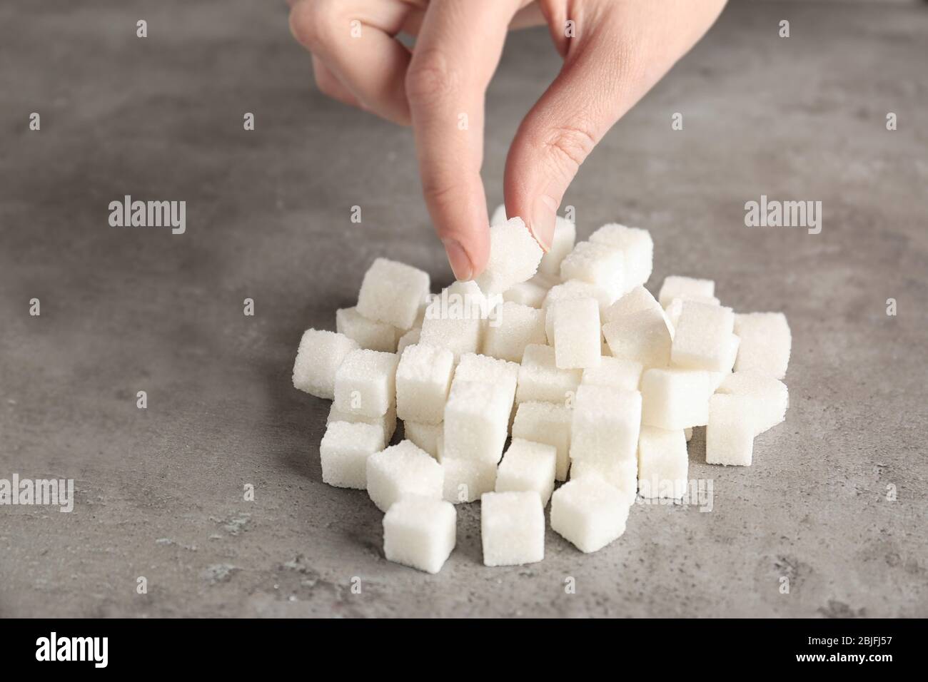 Fingers taking sweet hi-res stock photography and images - Alamy