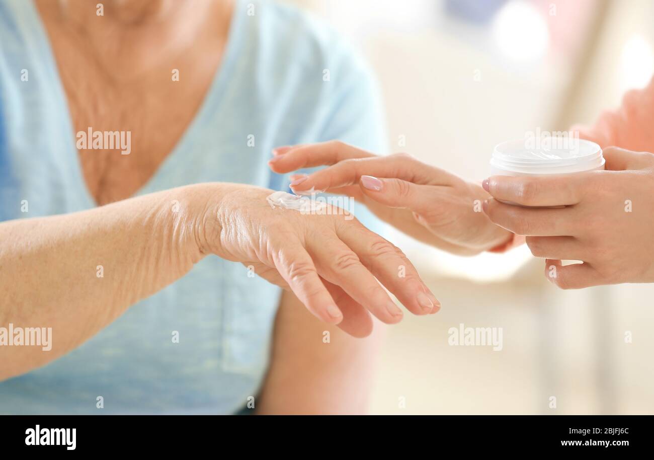 Doctor applying cream on female hi-res stock photography and images - Alamy
