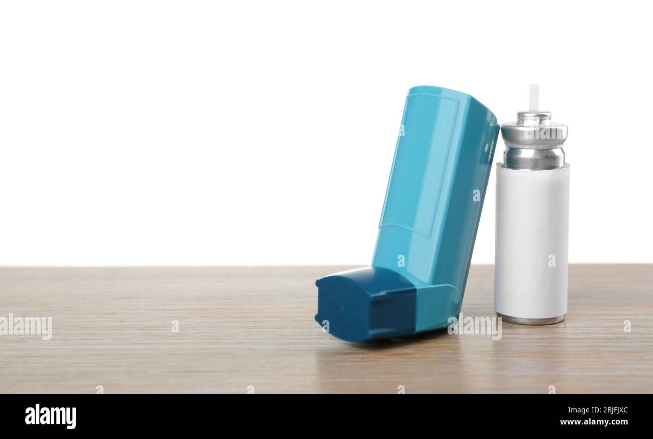 Asthma inhaler on wooden table Stock Photo - Alamy