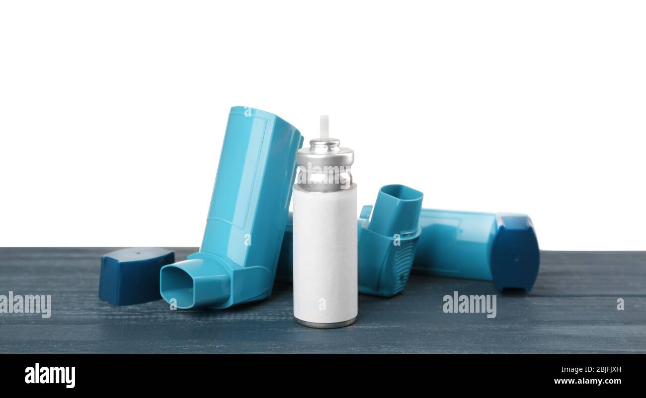 Asthma inhalers on wooden table Stock Photo - Alamy