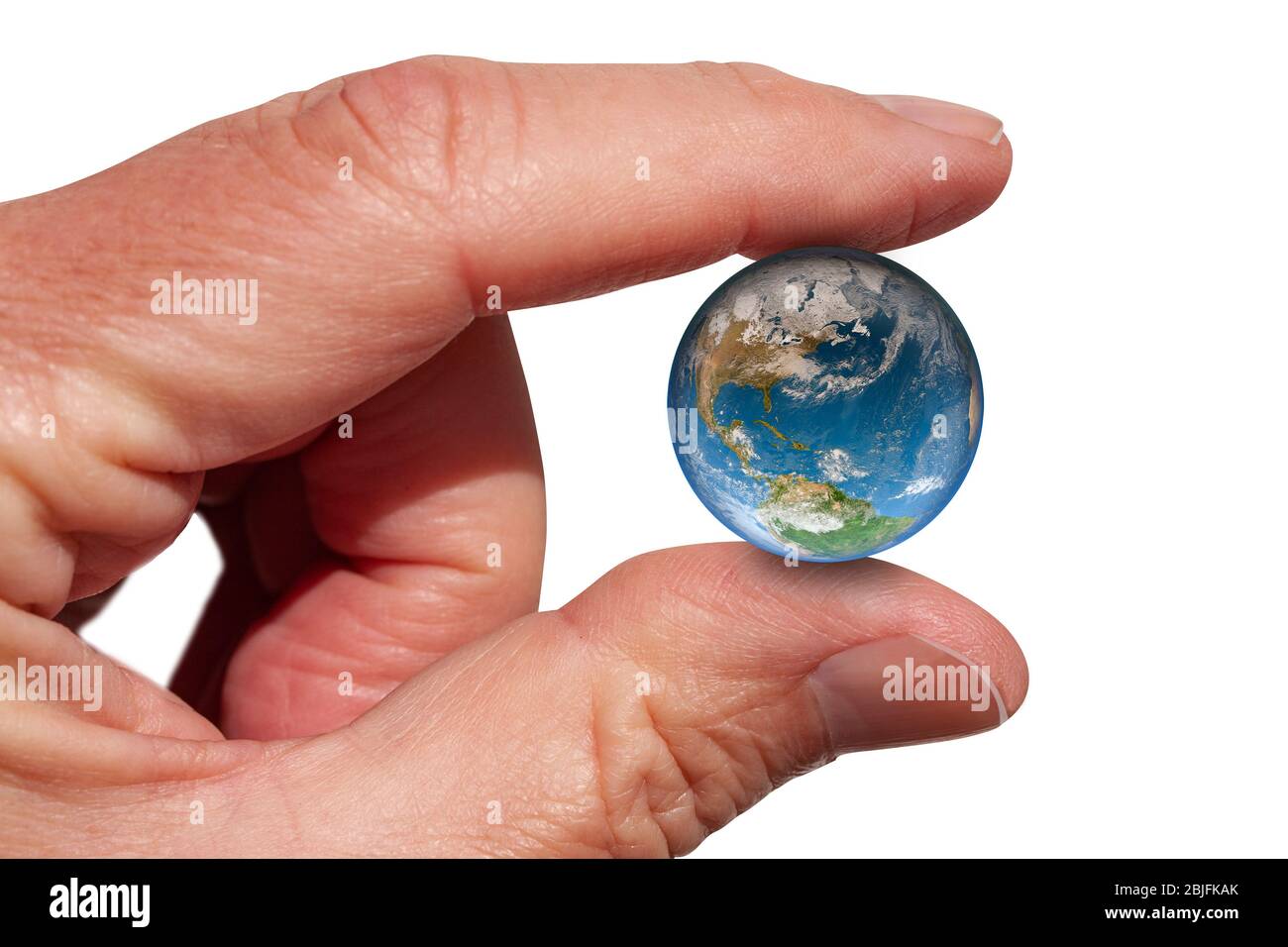 The Earth globe held between index finger and thump. The earth pinced ...