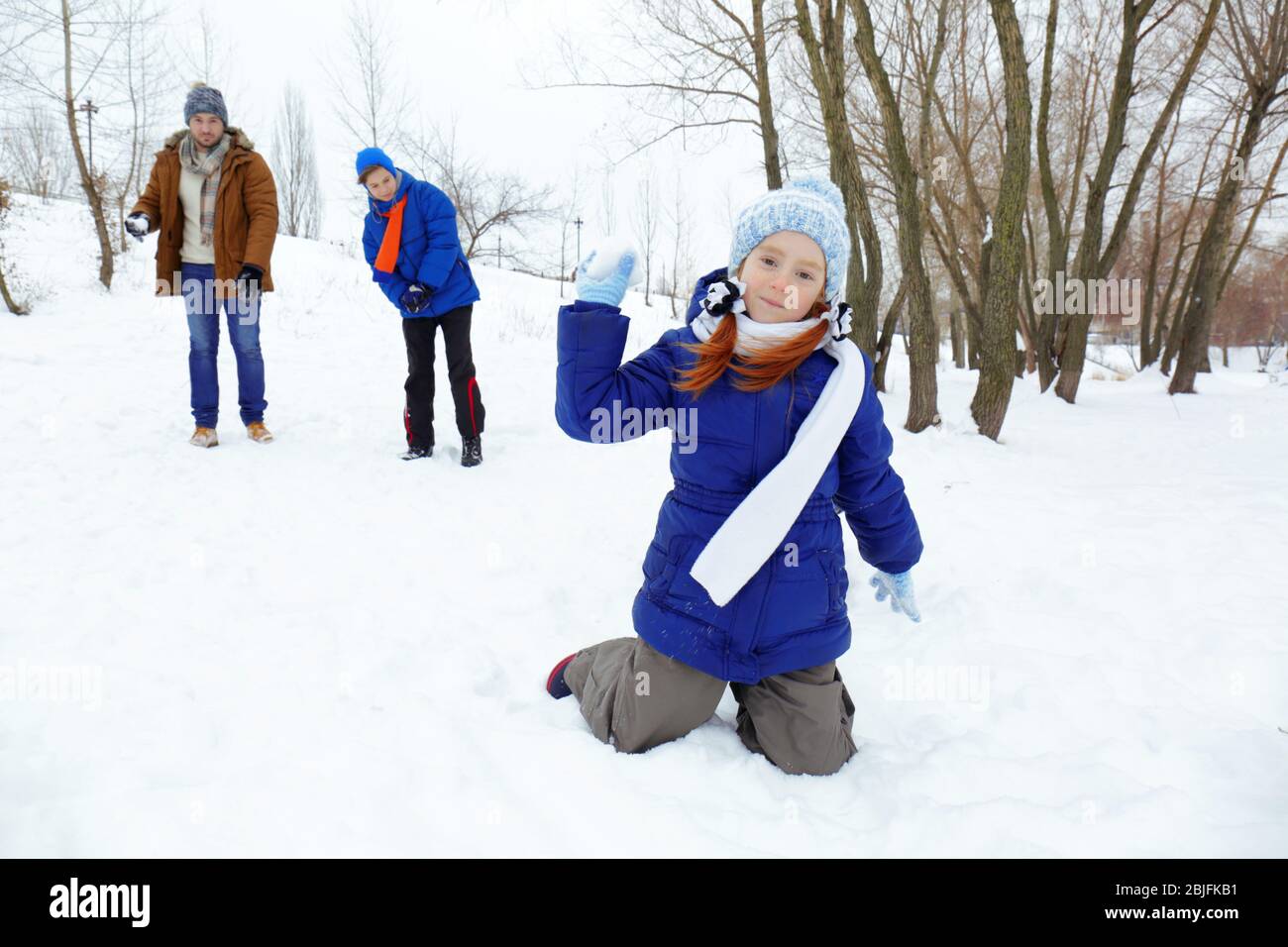 Kid playing snowball fight hi-res stock photography and images - Alamy