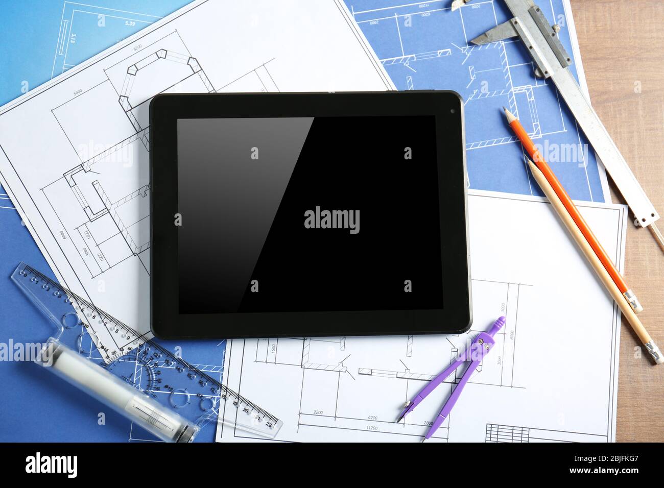 Blueprints, tablet and engineer supplies on table Stock Photo - Alamy