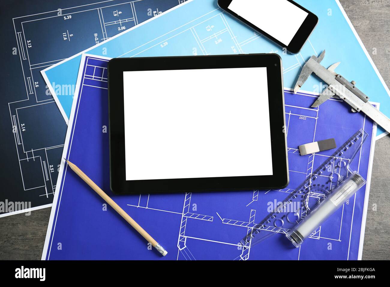 Blueprints, tablet and engineer supplies on table Stock Photo - Alamy
