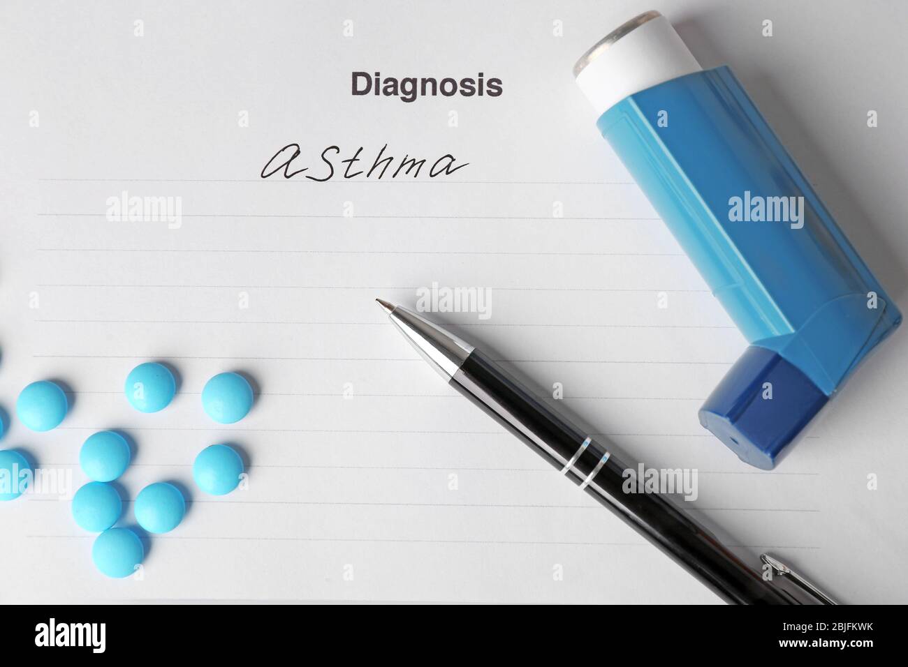 Asthma inhaler, pills and pen on diagnosis form Stock Photo - Alamy