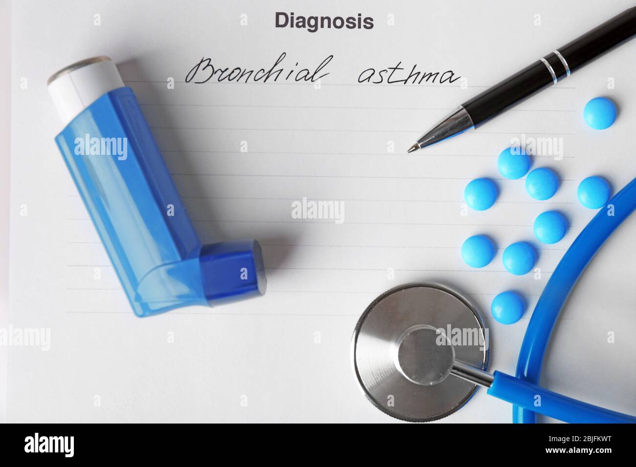 Asthma inhaler, pills and pen on diagnosis form Stock Photo - Alamy