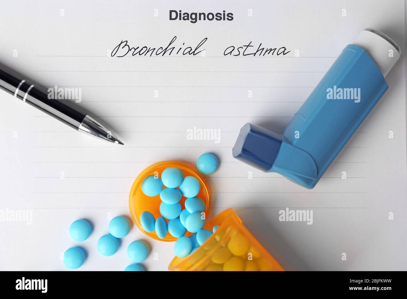 Asthma inhaler, pills and pen on diagnosis form Stock Photo - Alamy