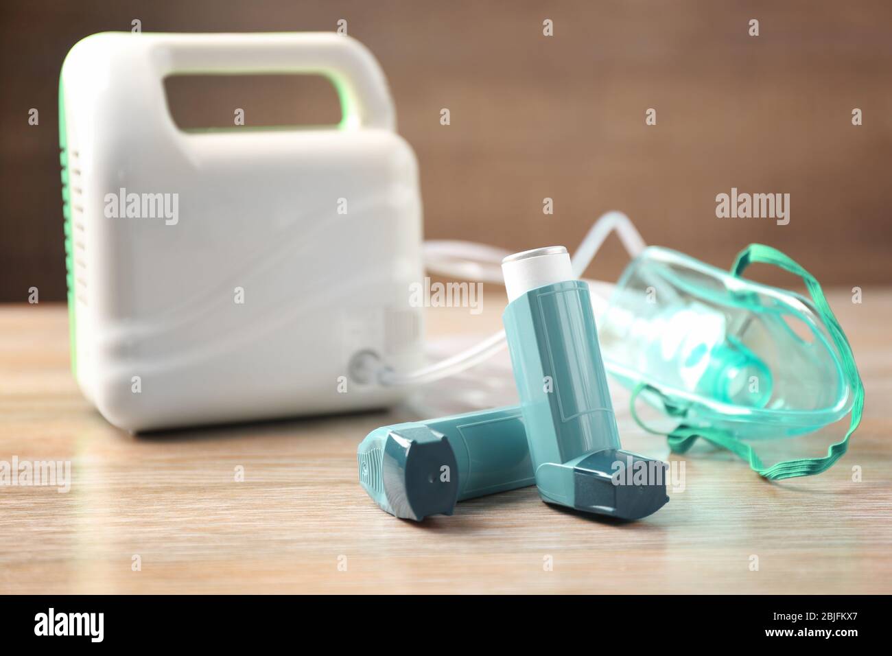 Asthma inhalers and nebuliser on wooden table Stock Photo - Alamy