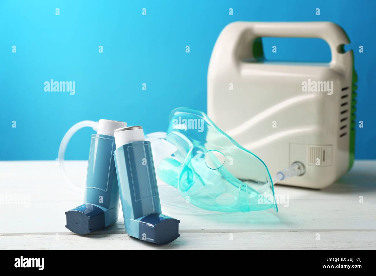 Asthma inhalers and nebuliser on blue background Stock Photo - Alamy