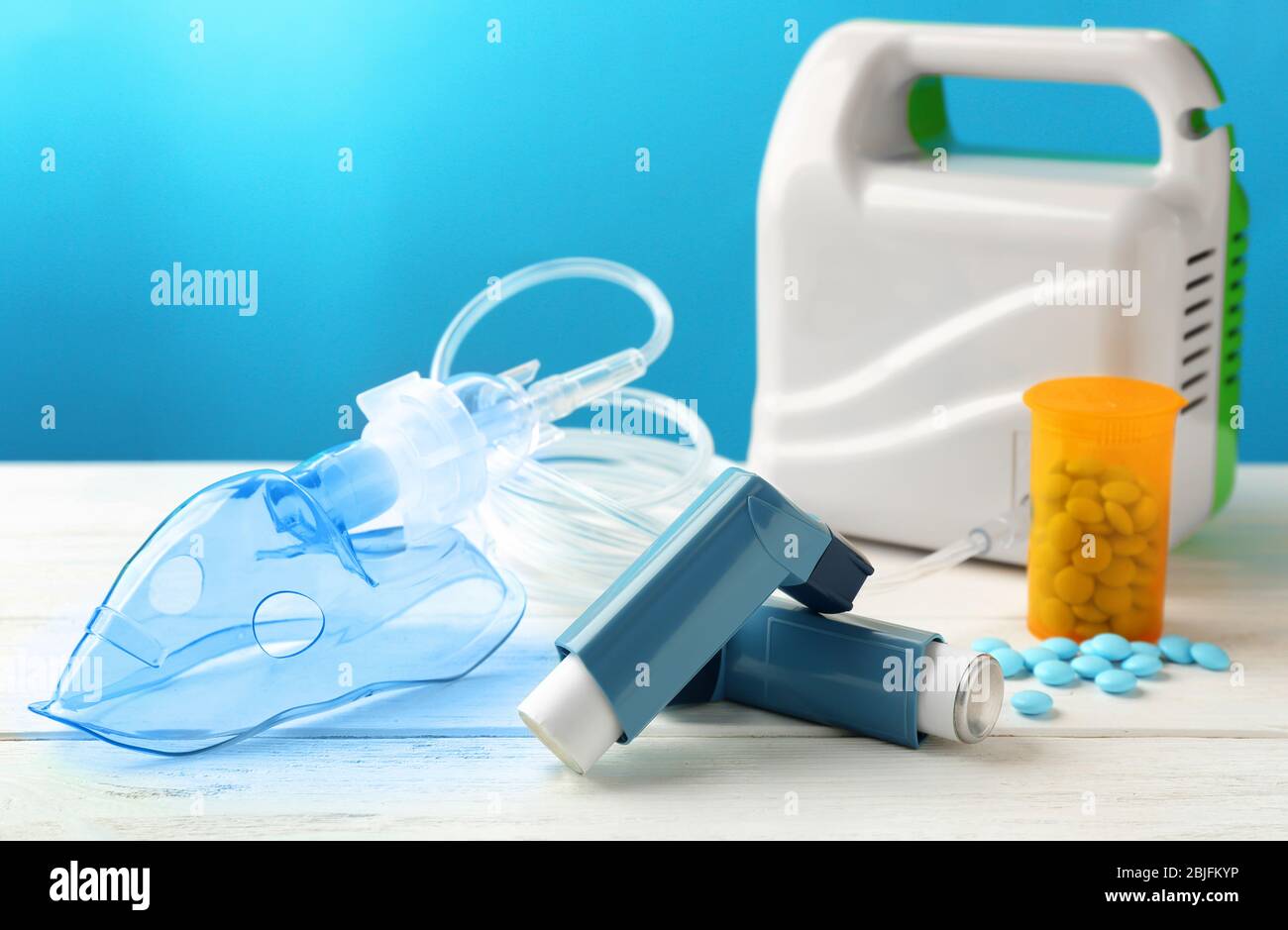 Asthma inhalers, nebuliser and pills on blue background Stock Photo - Alamy