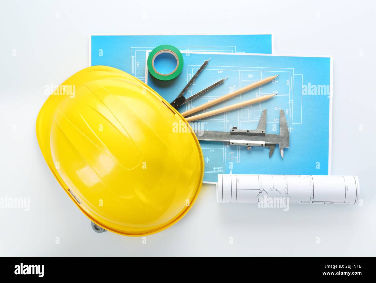 Blueprints, helmet and engineer supplies on white background Stock Photo - Alamy