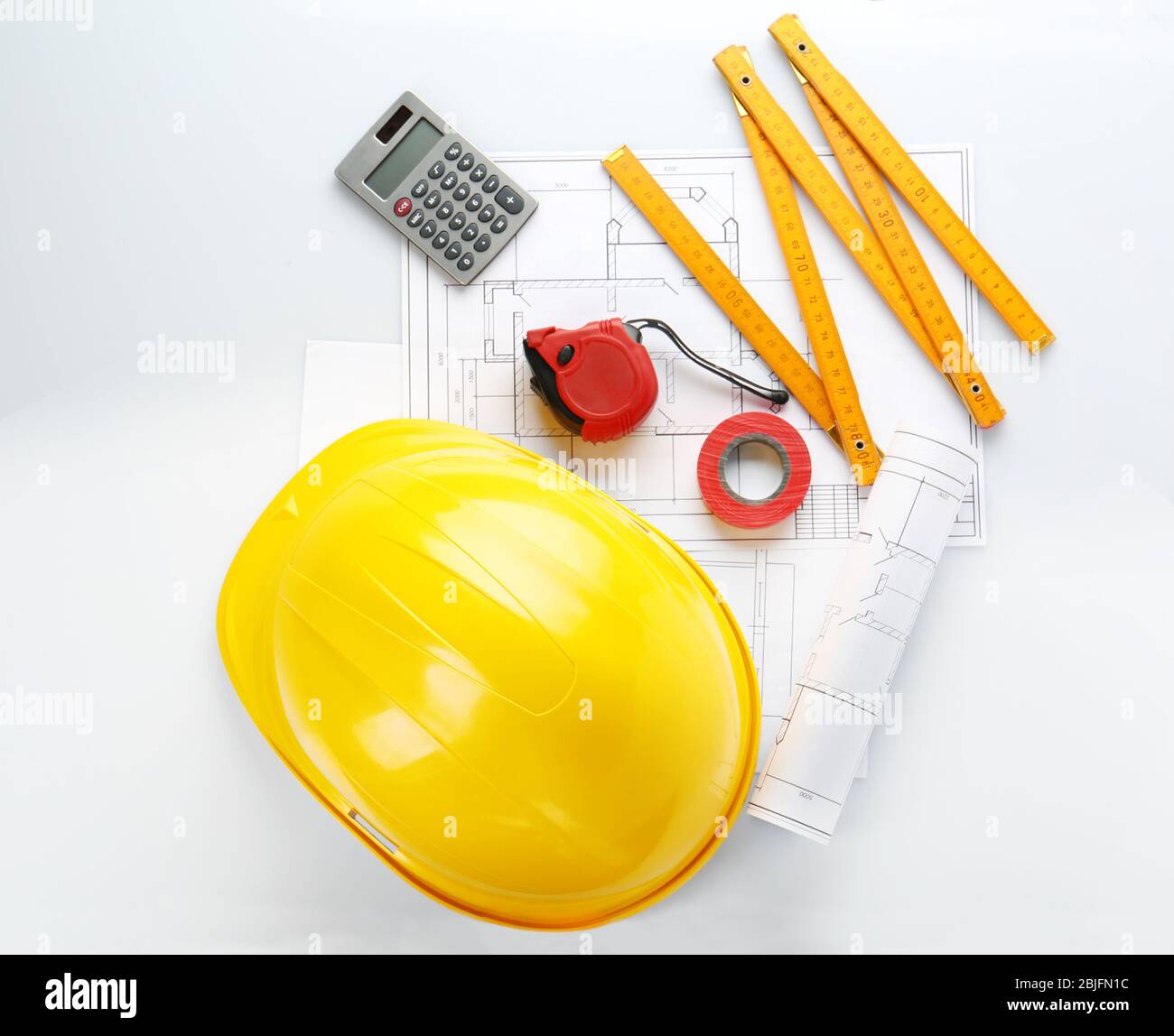 Blueprints, helmet and engineer supplies on white background Stock Photo - Alamy