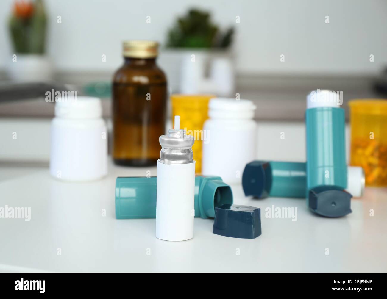 Asthma inhalers and medications on table Stock Photo - Alamy