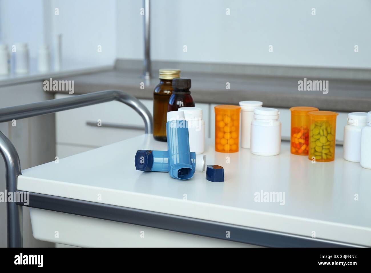 Asthma inhalers and medications on table Stock Photo - Alamy