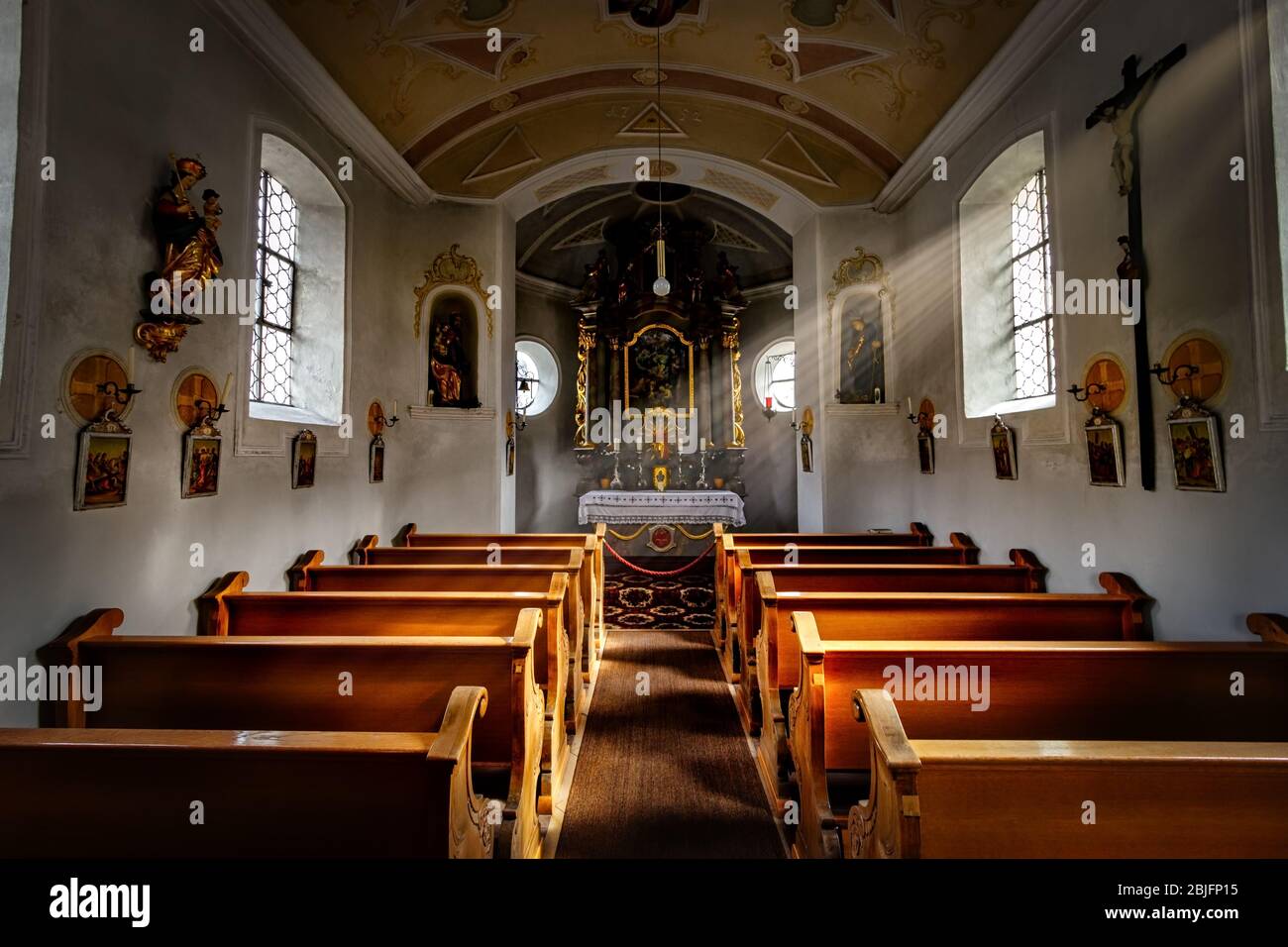 Inside a small, dimly lit, Bavarian church in Garmisch-Partenkirchen ...
