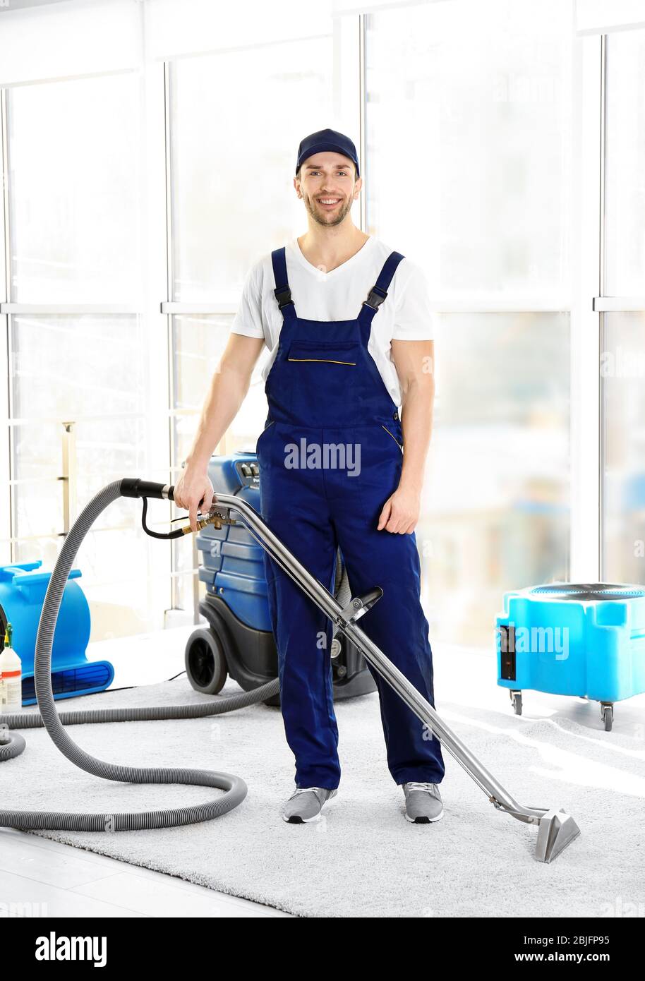 Dry cleaners man employee removing hi-res stock photography and images ...