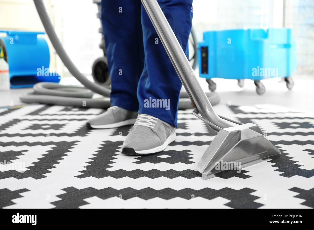 Dry cleaners man employee removing hi-res stock photography and images ...