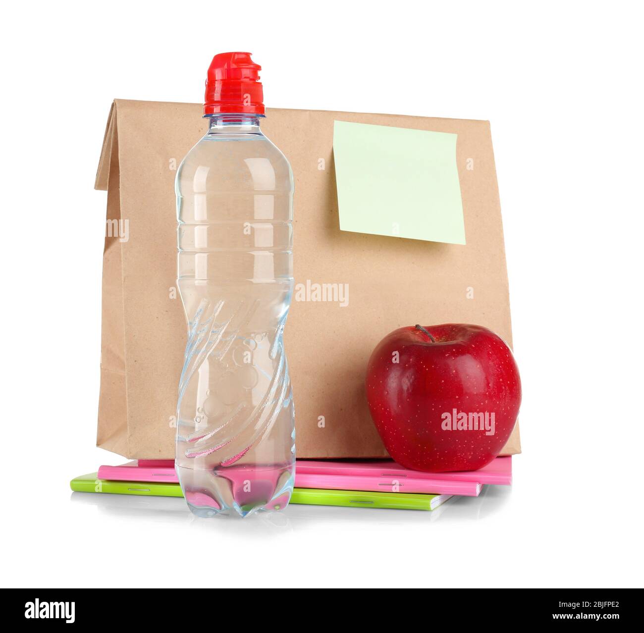 Paper lunch bag with reminder, bottle of water, apple and colorful ...
