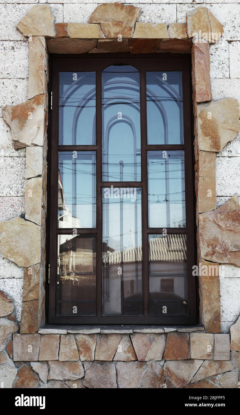 Large window with metal mesh on stone wall background Stock Photo - Alamy