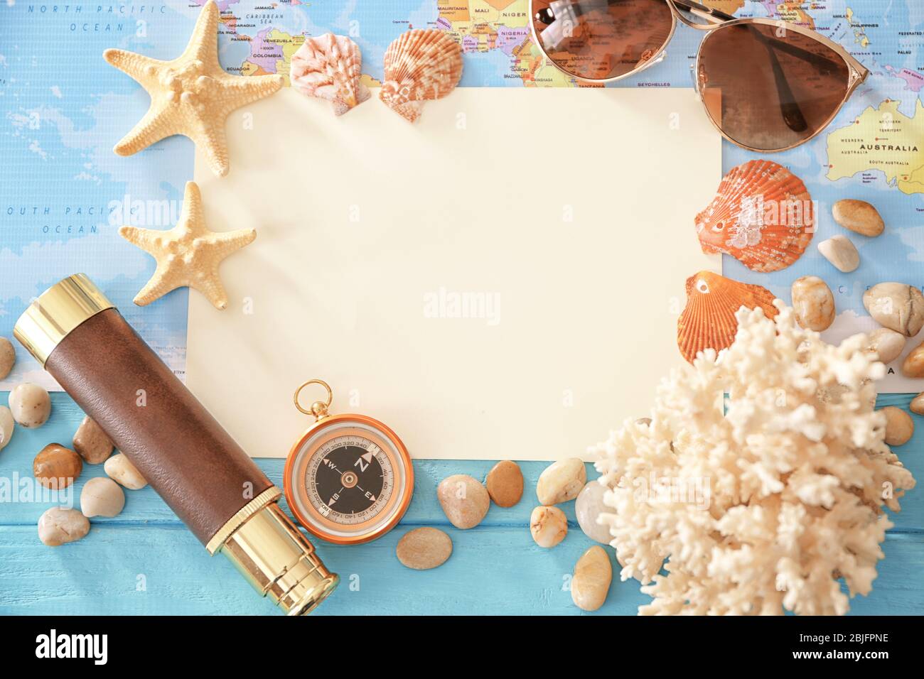 Travel concept. Composition with paper and sea shells on world map ...