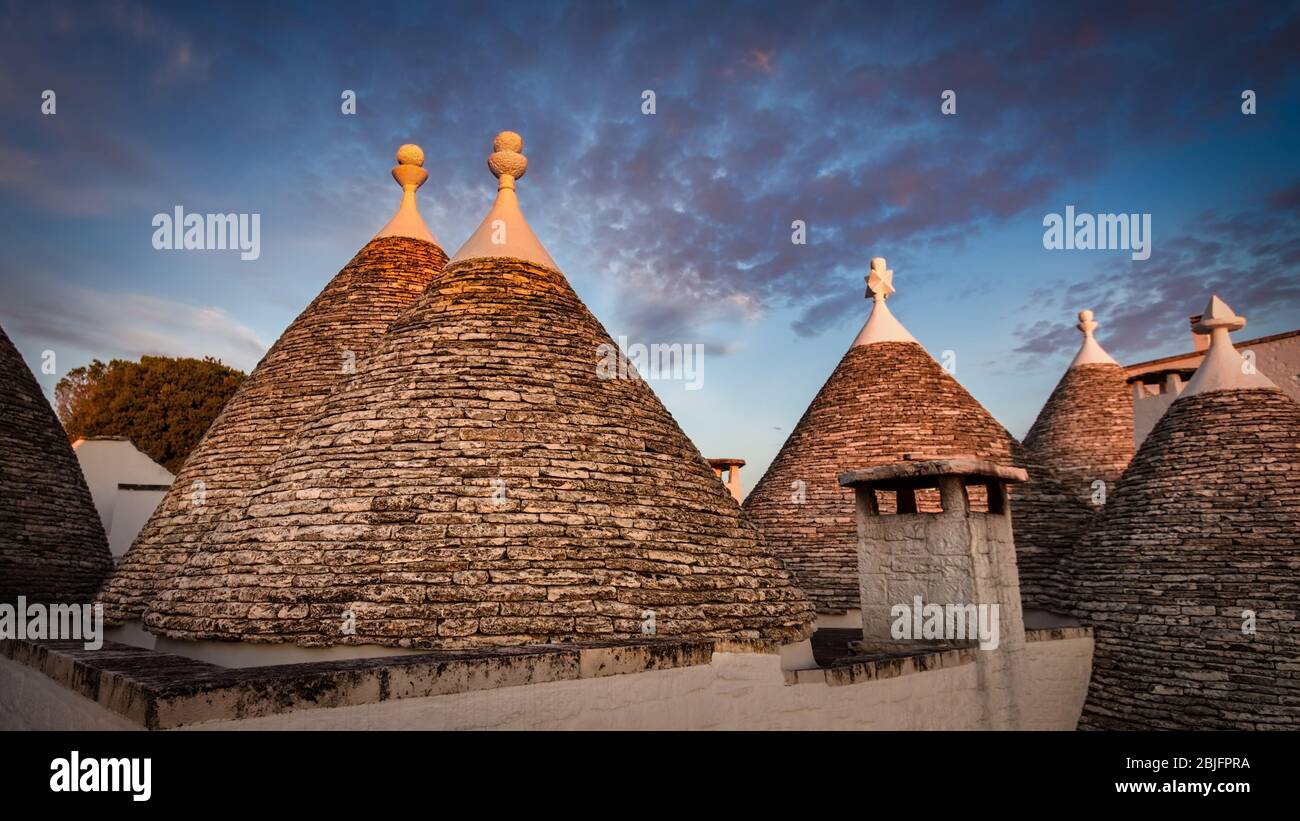 The sun rises on the Trulli House rooftops in Alberobello, Italy in the ...