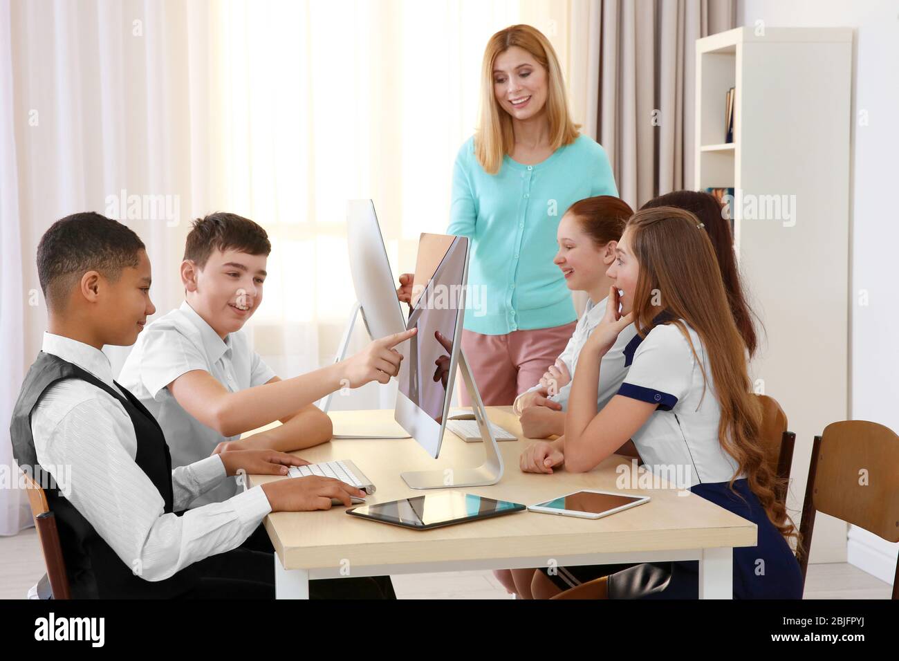 Young teenagers at computers in class hi-res stock photography and ...