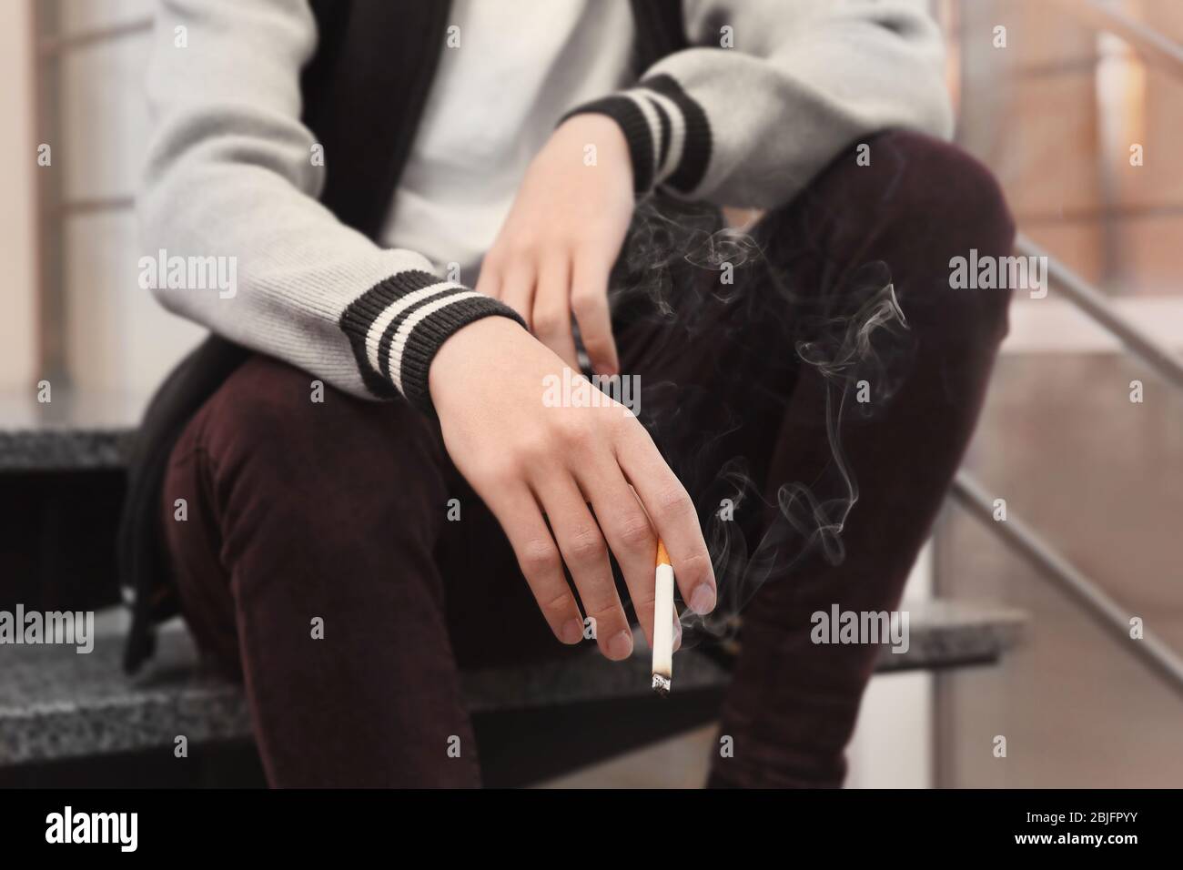 Teenage boy holding cigarette, closeup Stock Photo - Alamy