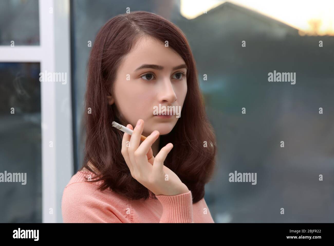 Girl smoking by window hi-res stock photography and images - Alamy