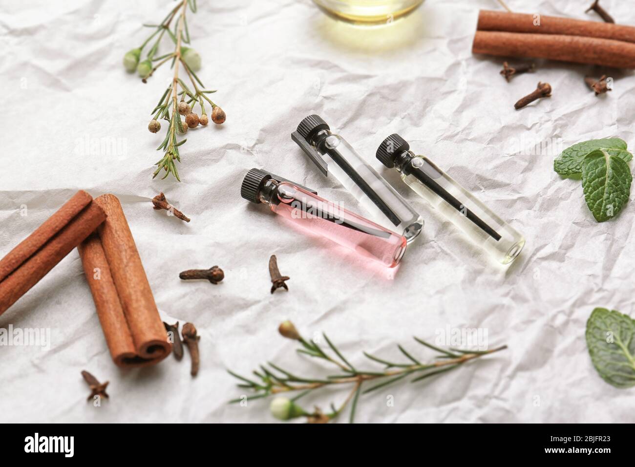 Beautiful composition with perfume samples on crumpled paper background ...