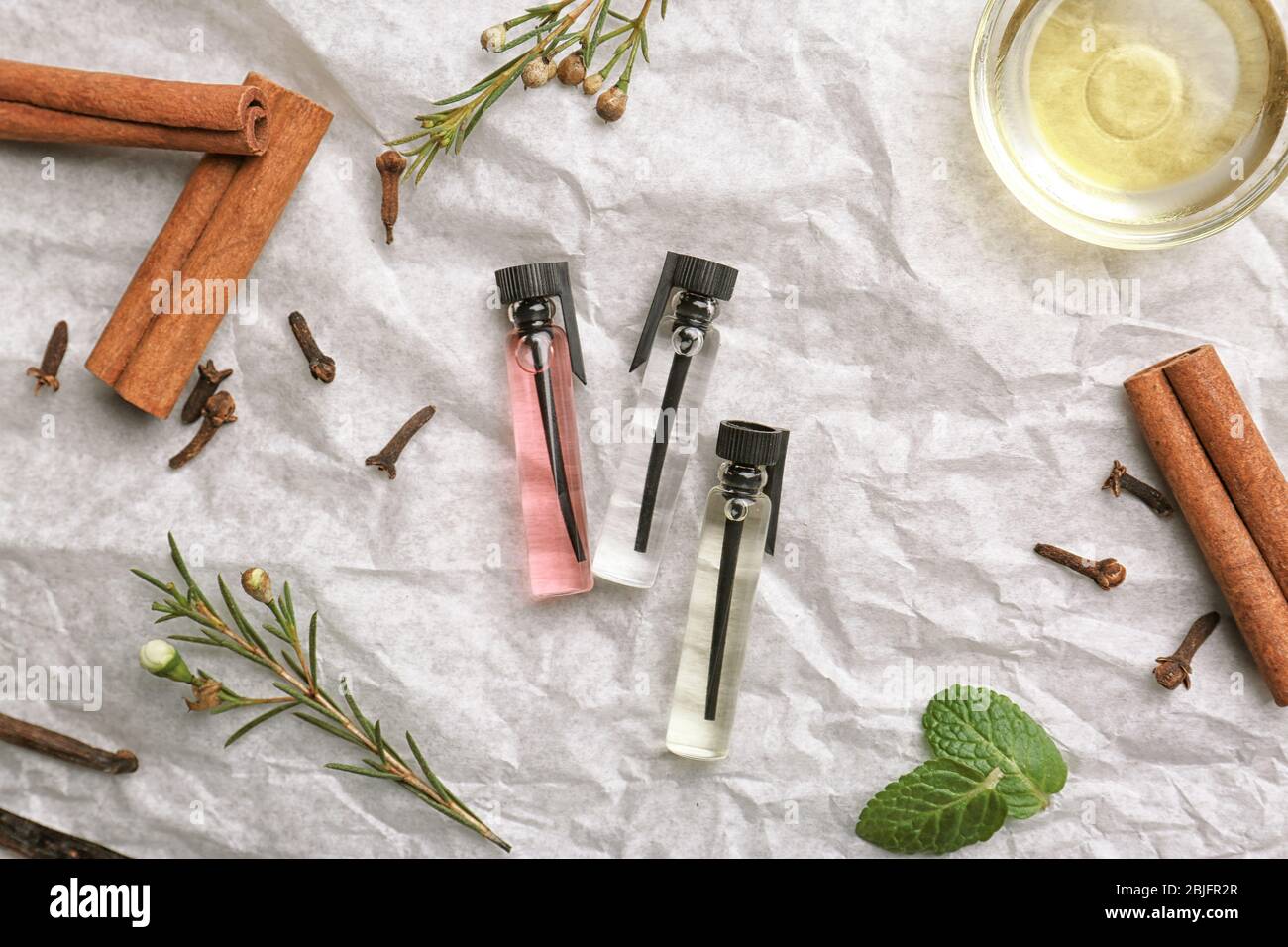 Beautiful composition with perfume samples on crumpled paper background ...