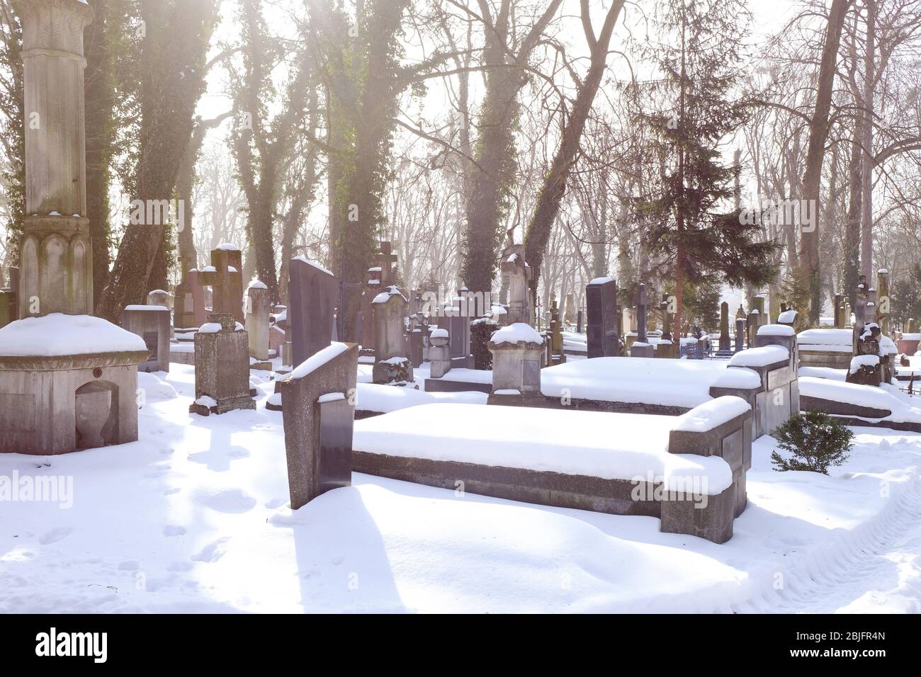 Cemetery with tombstones in winter Stock Photo - Alamy