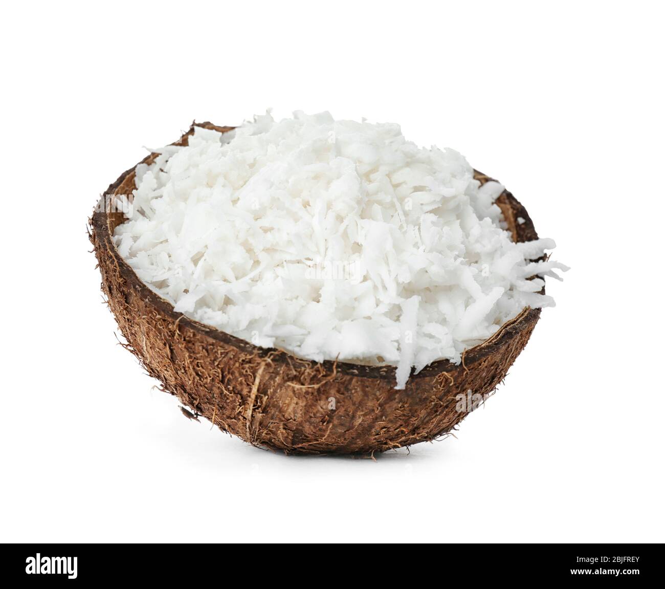 Grated coconut in shell on white background Stock Photo - Alamy